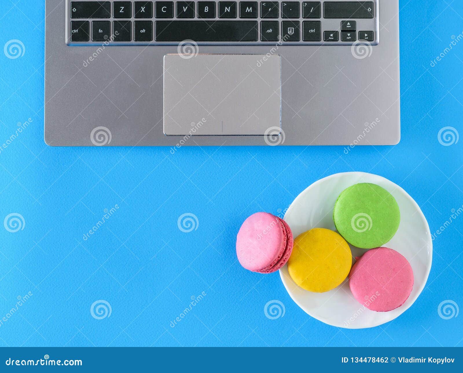 Colored Macaroons in a White Bowl on a Blue Background with the ...