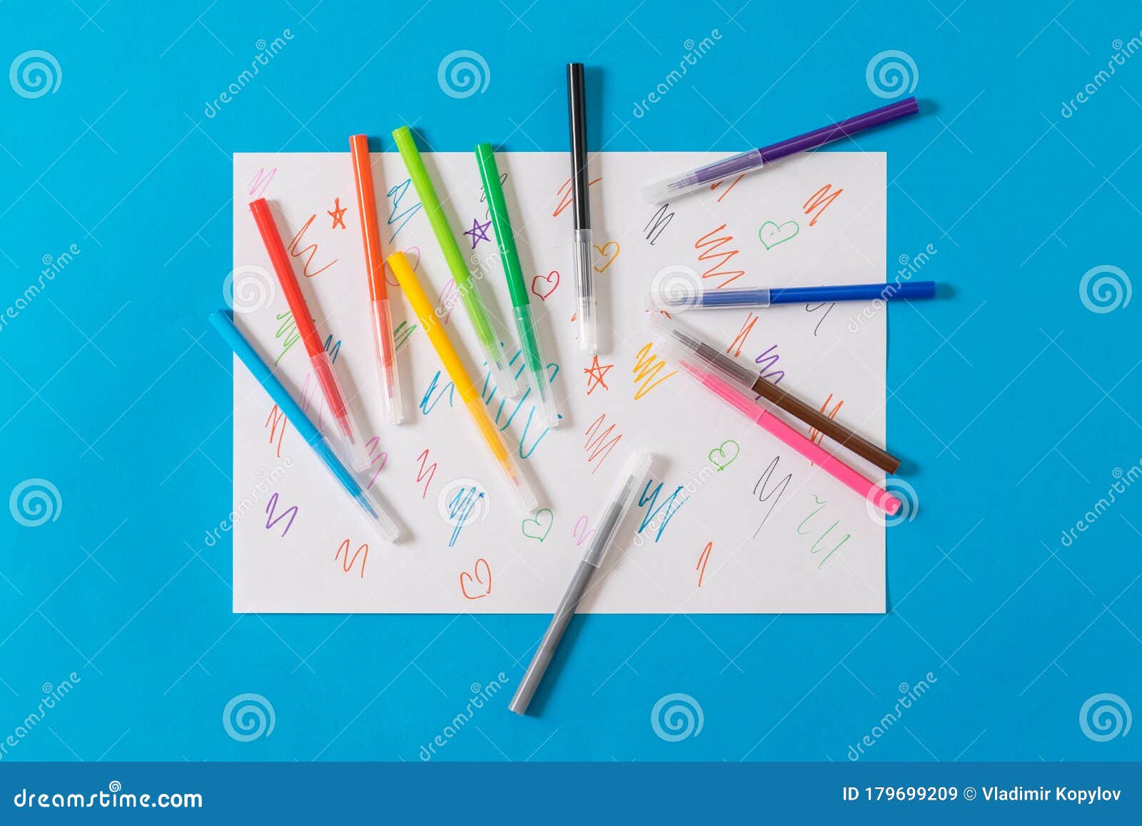 Colored Markers on a Painted Sheet of Paper on a Blue Background. Stock ...