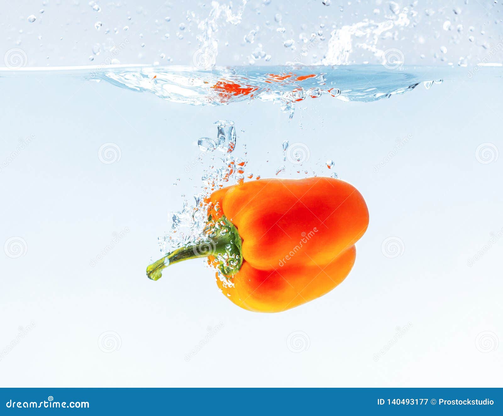 Colored Orange Paprika in Water Splashes on Blue Background Stock Image ...
