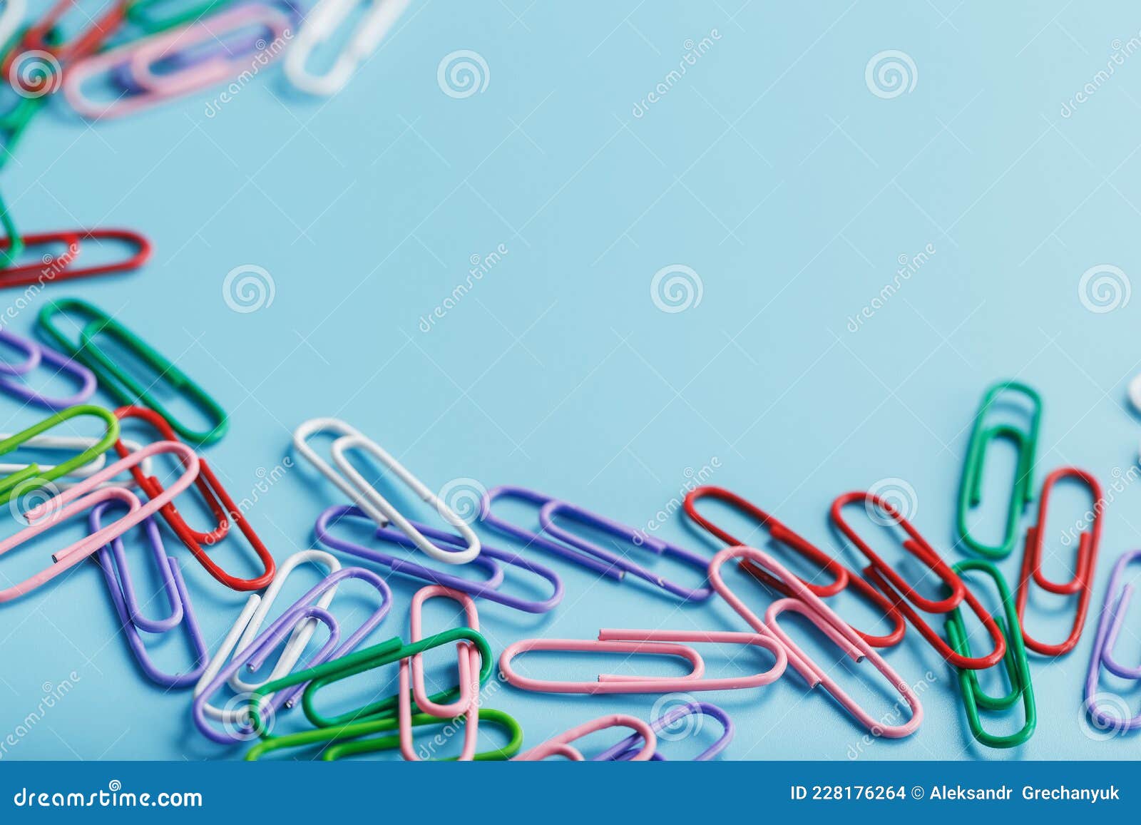 Colored Paper Clips on a Blue Background with Free Space Stock Photo ...