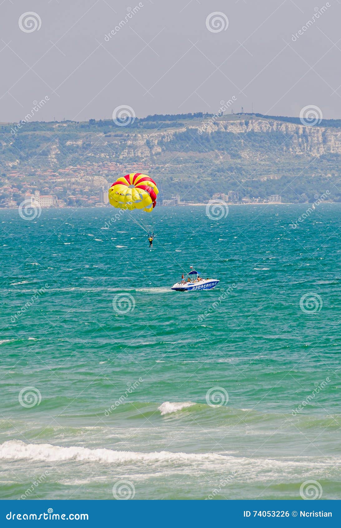Colored Parasail Wing Pulled by a Boat in the Blue Water Sea. Editorial ...