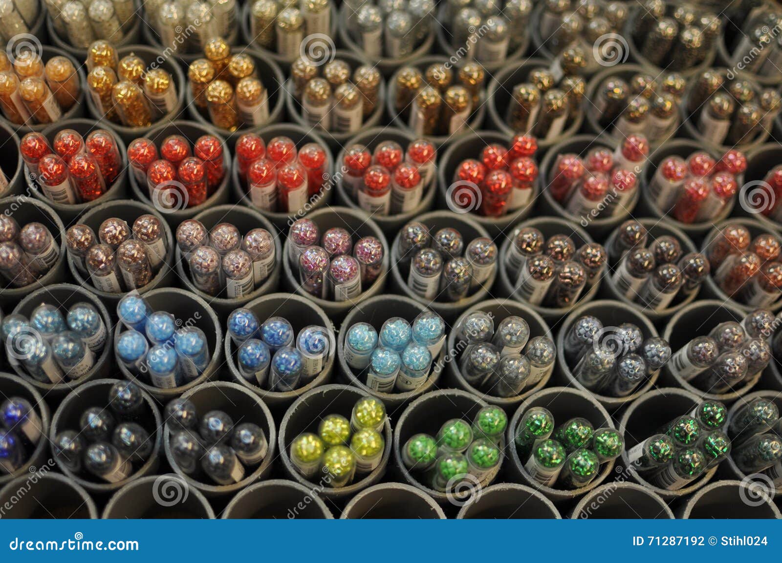Colored pearls in tubes stock photo. Image of displayed - 71287192