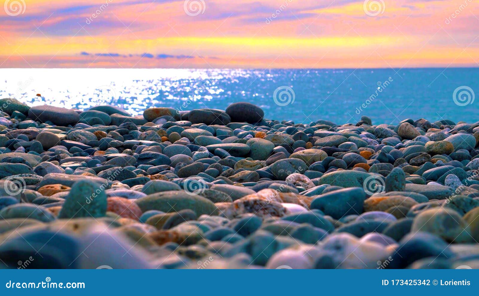 Colored pebbles on a beach stock photo. Image of idyllic - 173425342