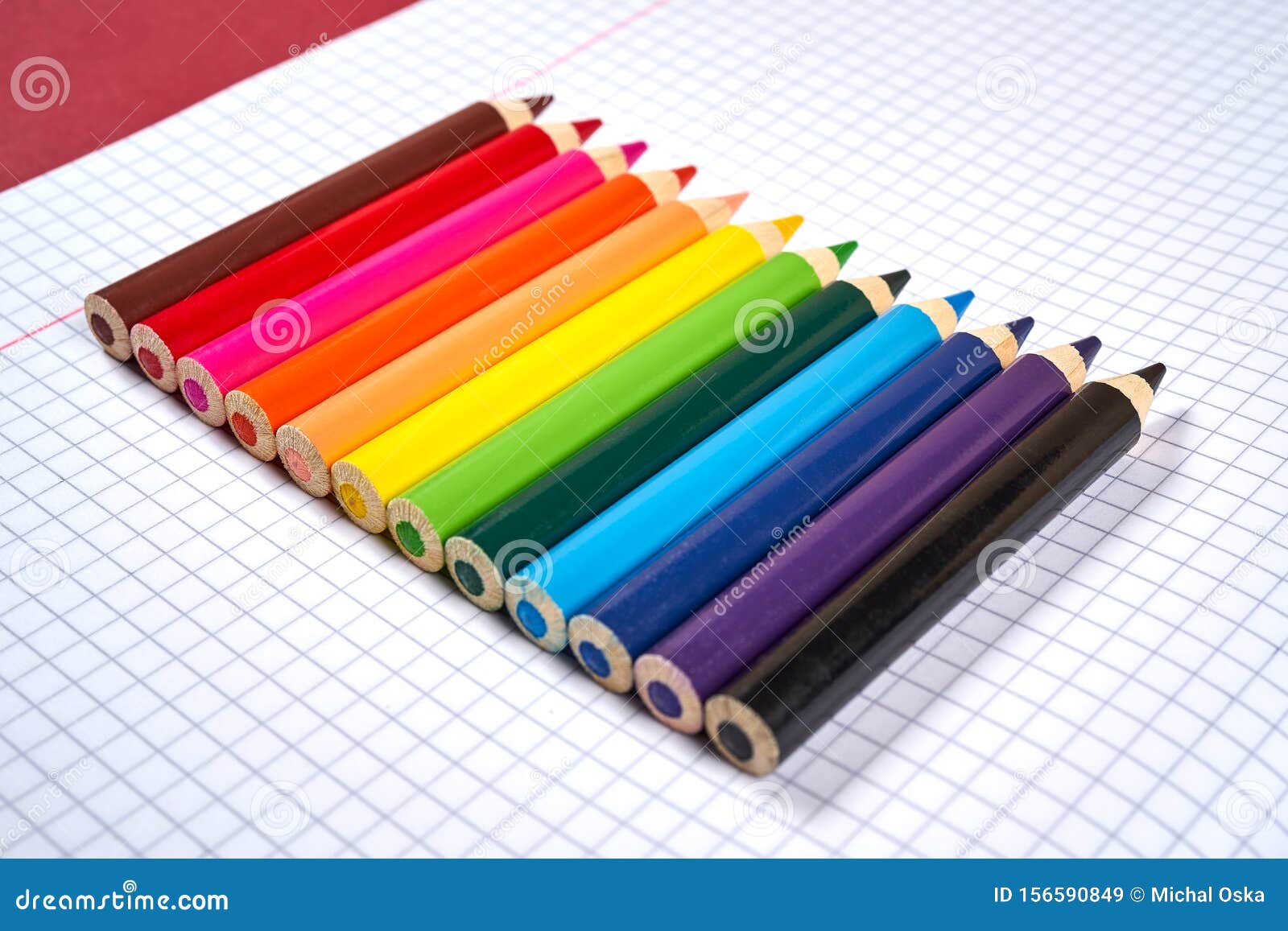 Colored Pencil Crayons on an Open Checkered Notebook Stock Image ...