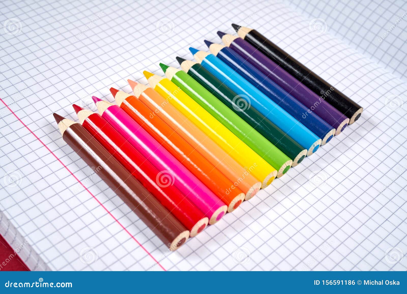 Colored Pencil Crayons on an Open Checkered Notebook Stock Photo ...