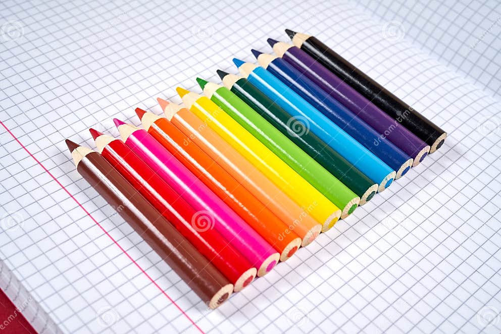 Colored Pencil Crayons on an Open Checkered Notebook Stock Photo ...