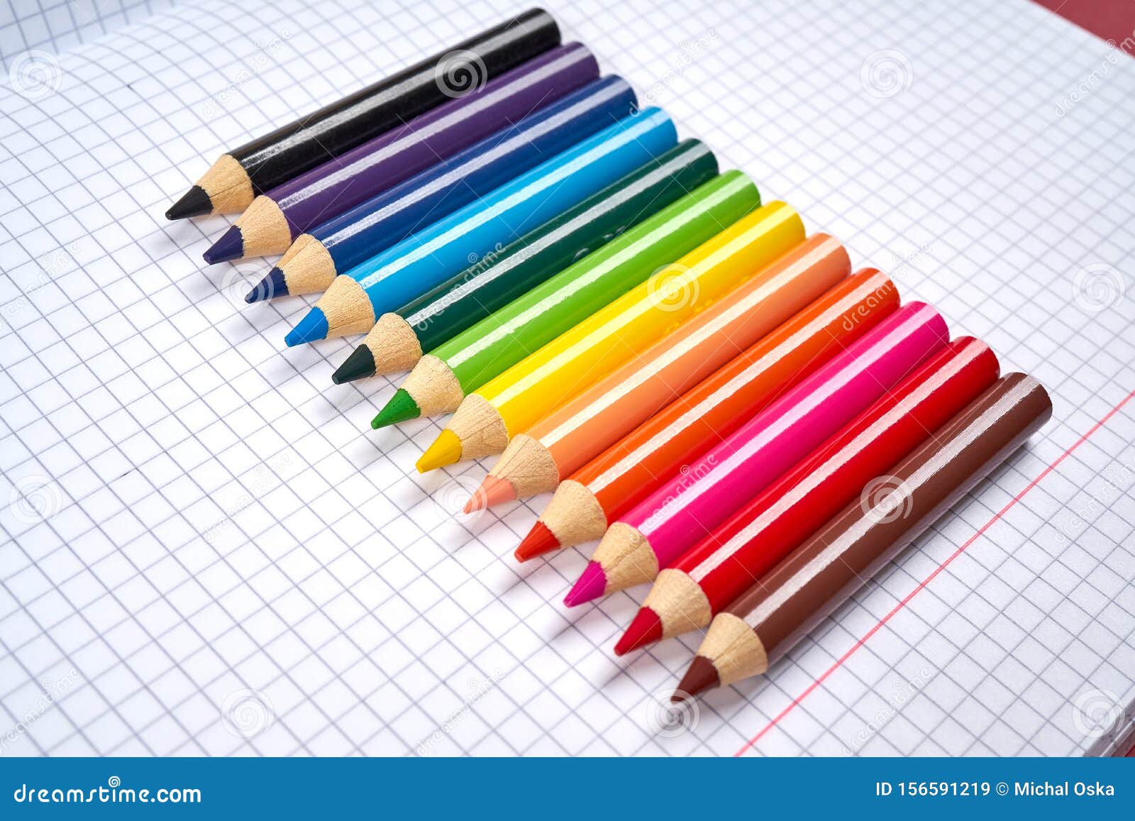 Colored Pencil Crayons on an Open Checkered Notebook Stock Image ...