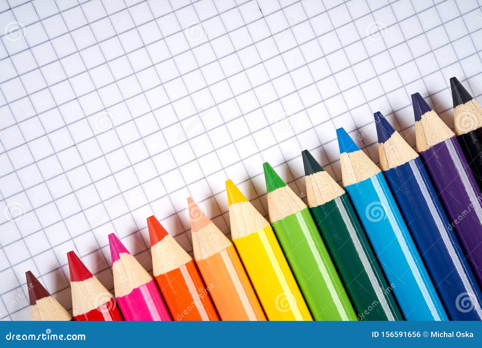 Colored Pencil Crayons on an Open Checkered Notebook Stock Photo ...