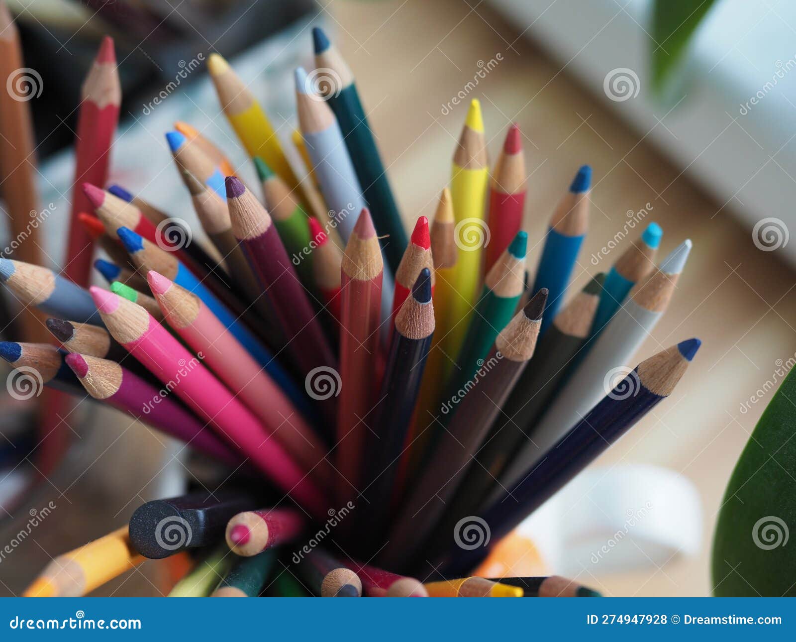 Colored Pencils are in a Glass on the Table in a Creative Mess Stock ...