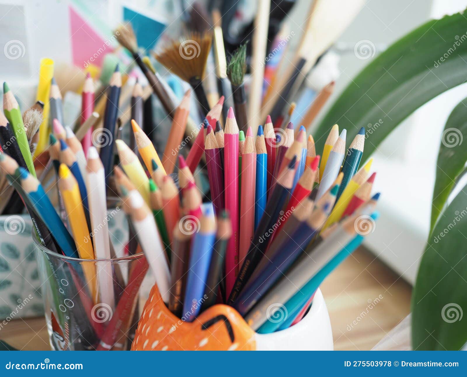 Colored Pencils are in a Glass on the Table in a Creative Mess Stock ...