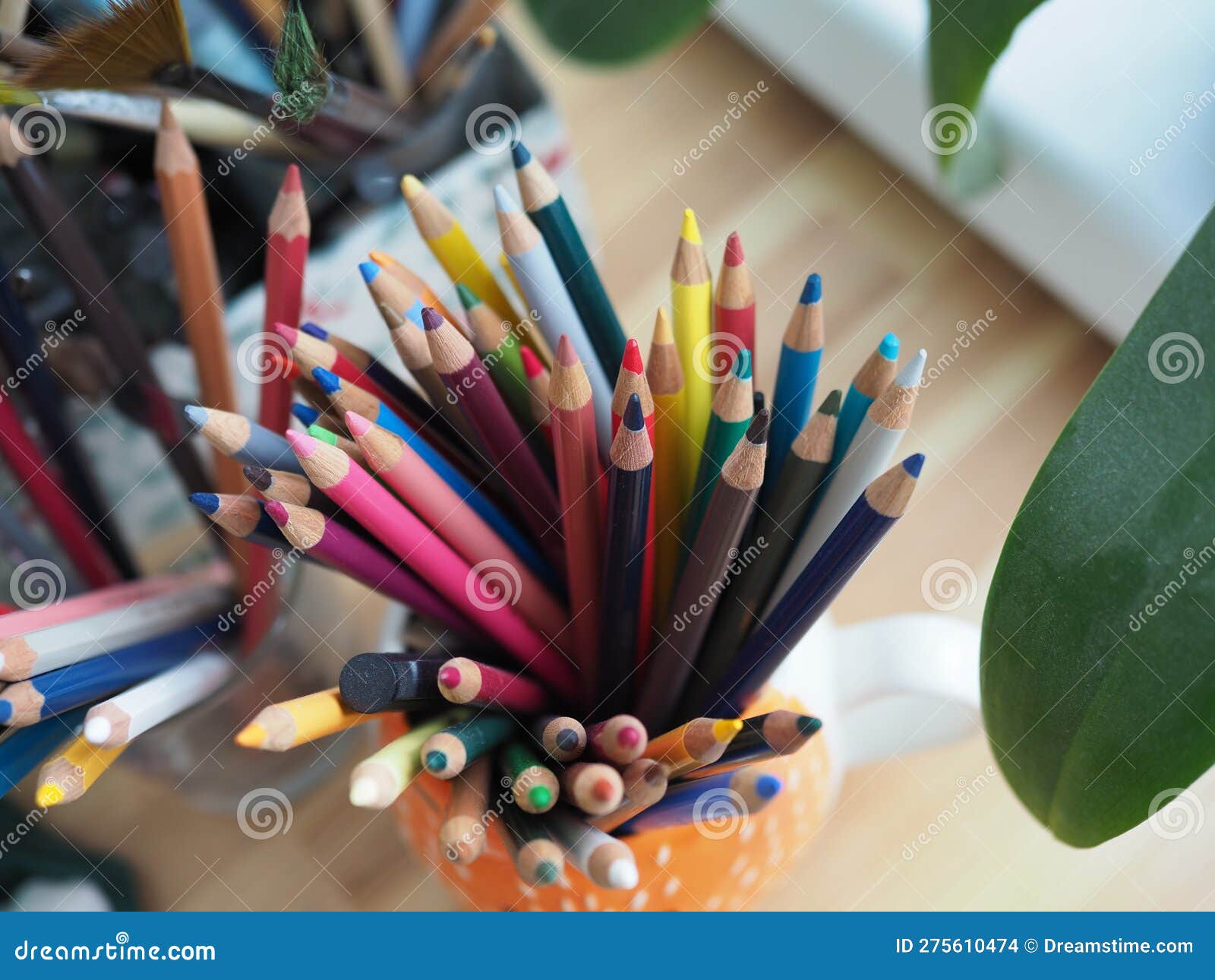 Colored Pencils are in a Glass on the Table in a Creative Mess Stock ...