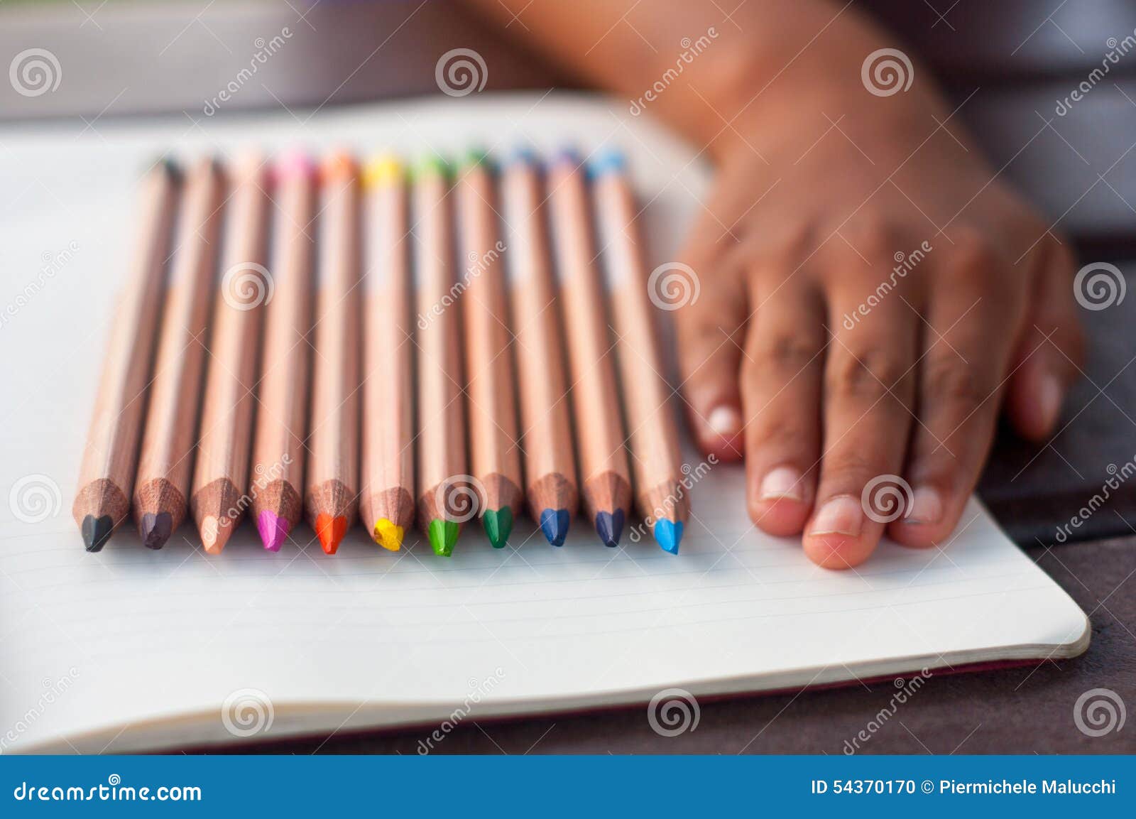 Colored pencils with hand stock photo. Image of green - 54370170