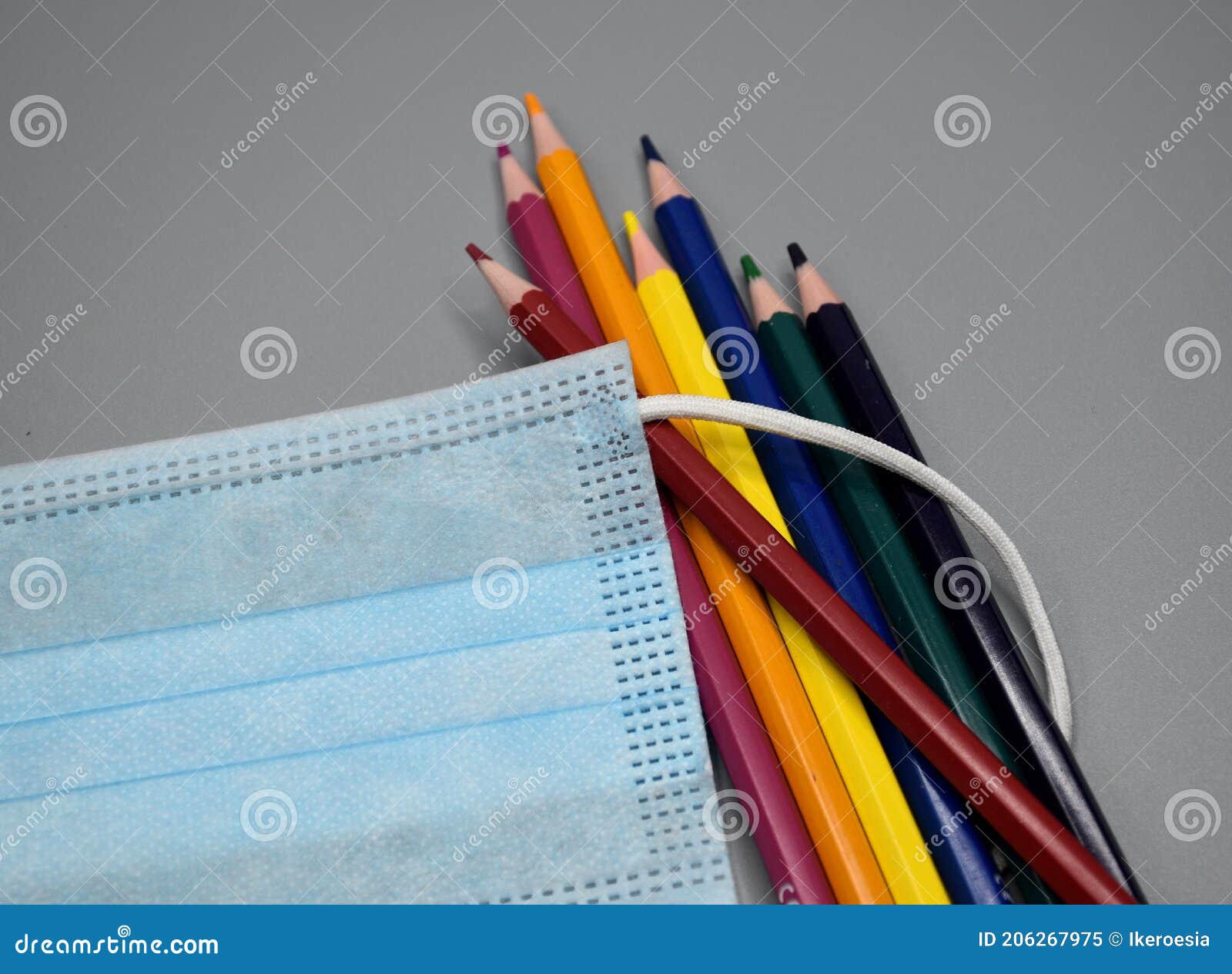 Handful of Colored Pencils Inside the Elastic Rubber of a Surgical Mask ...