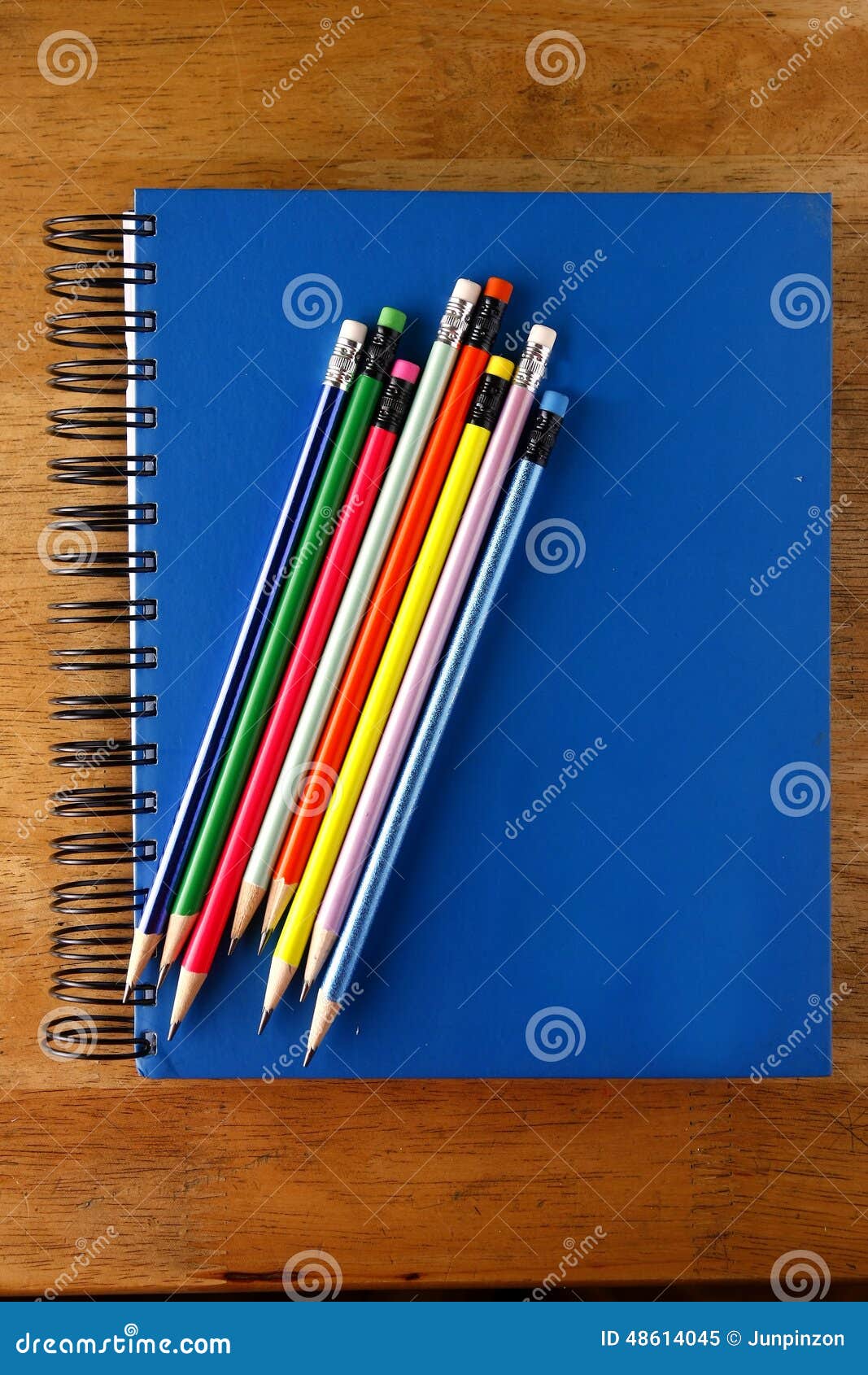 Colored Pencils and a Notebook on a Table Stock Image - Image of notes ...