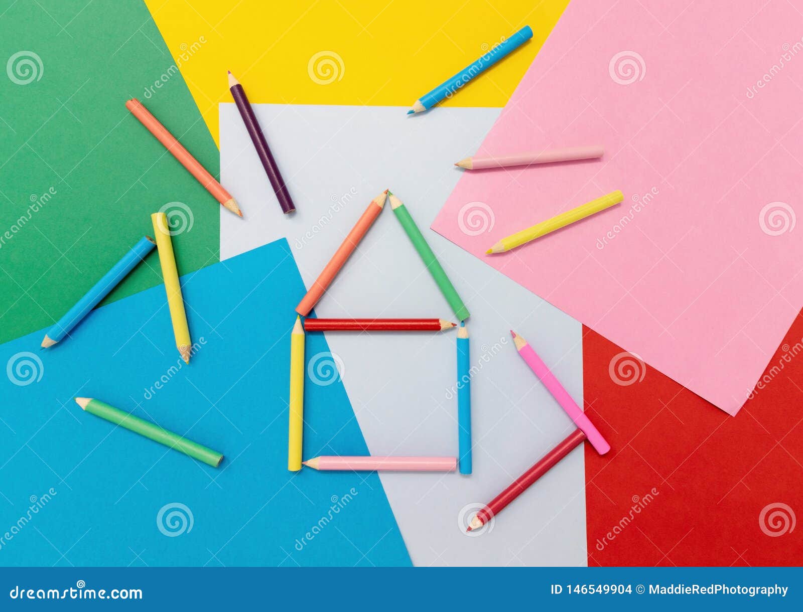 Colored Pencils in the Shape of a House on Colored Paper Stock Photo ...