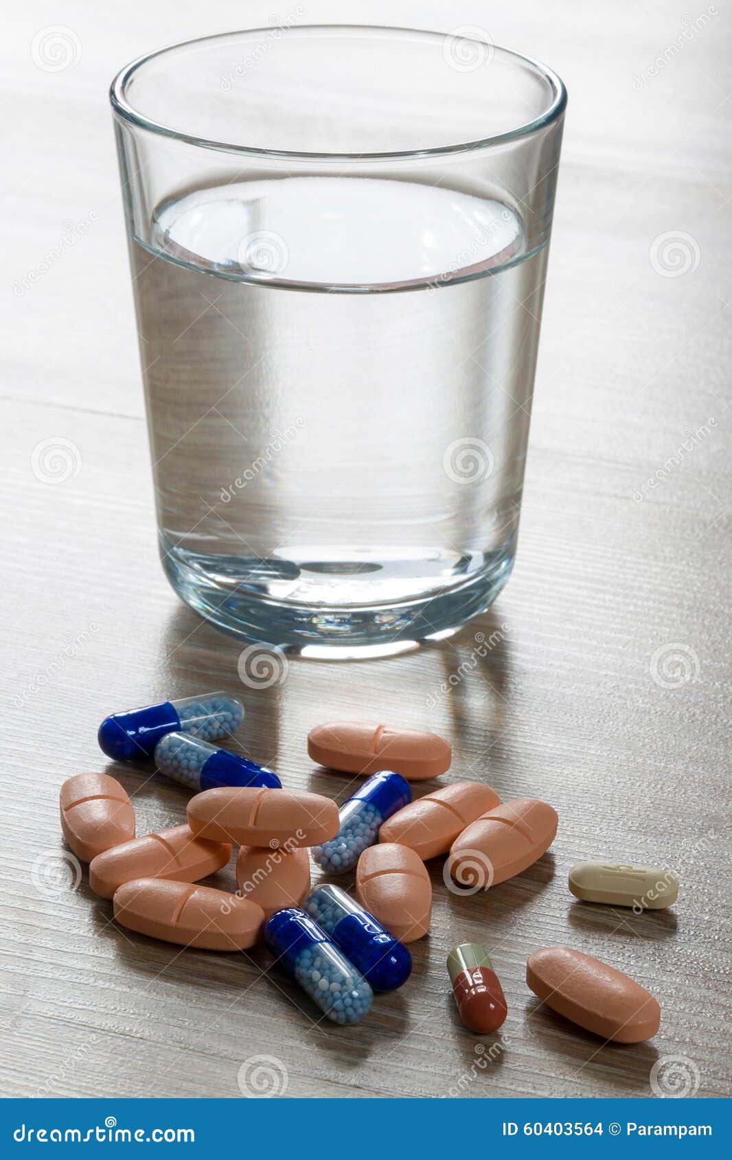 Colored Pills and a Glass of Water Stock Photo - Image of tablet ...
