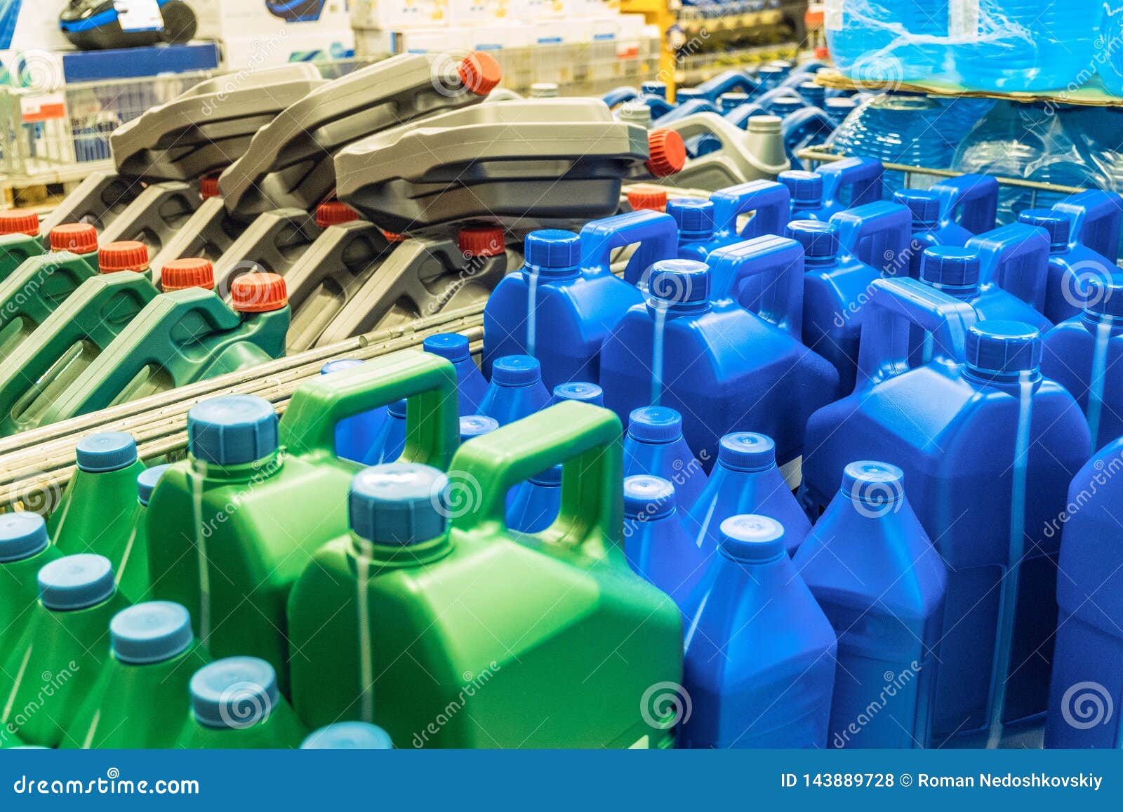 Colored Plastic Cans with Engine Oil. Canisters on a Pallet. Stock ...
