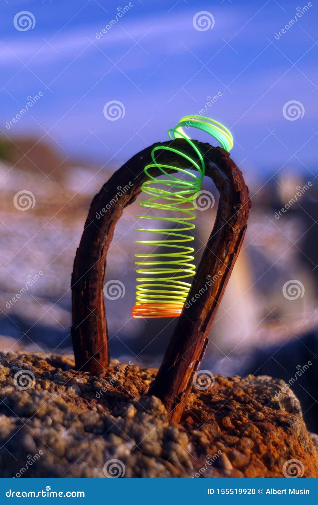 Colored Plastic Spring on a Rusty Loop of Reinforced Concrete Shore ...