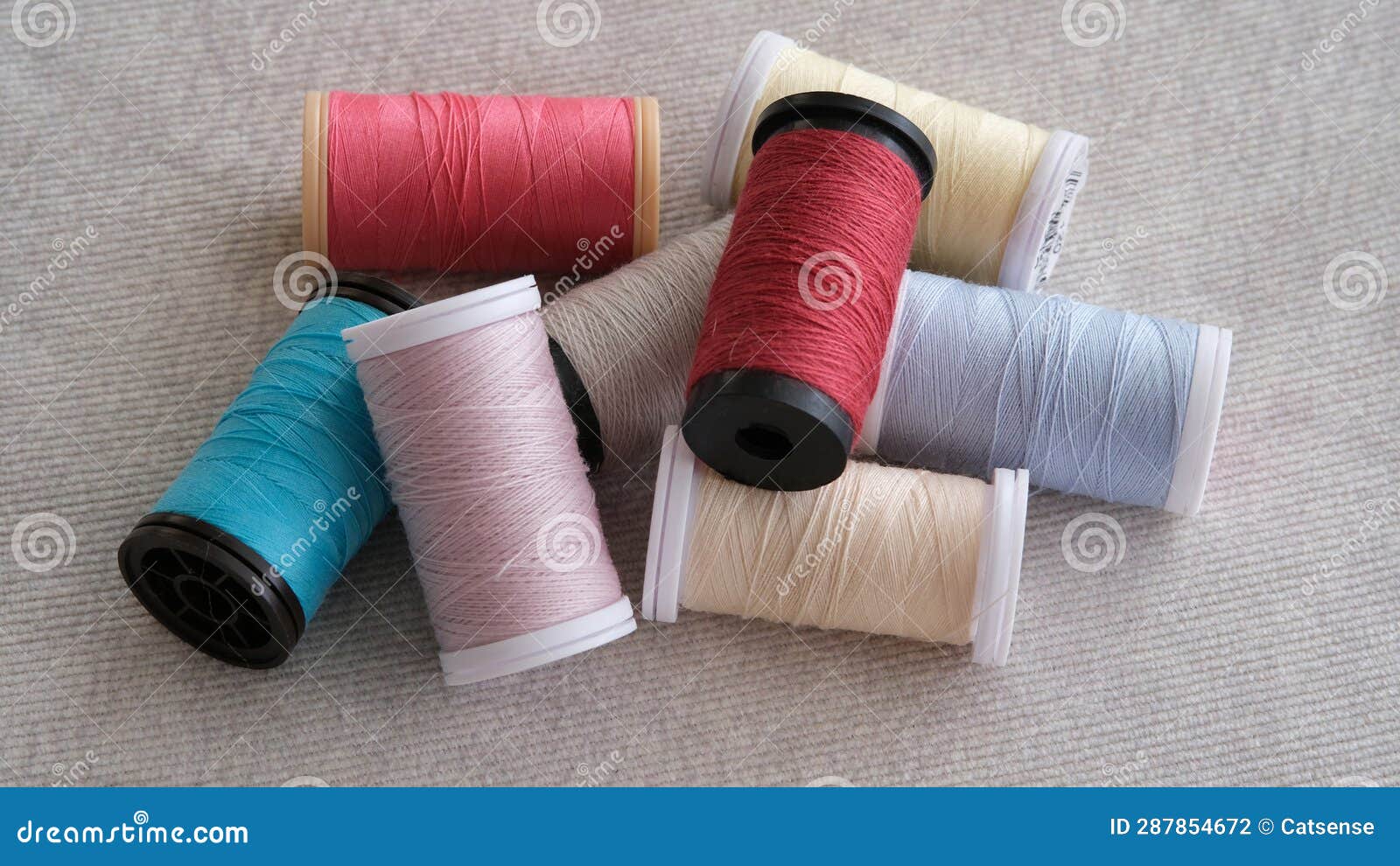 Colored Sewing Thread Reels on Fabric Stock Photo - Image of fabric ...