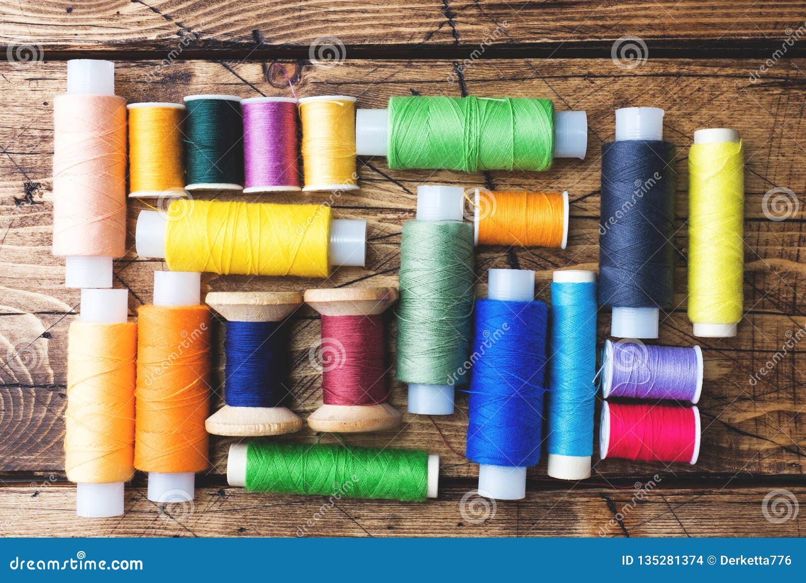 Colored Spools of Thread Laid Out in Rows on Wooden Background Stock ...