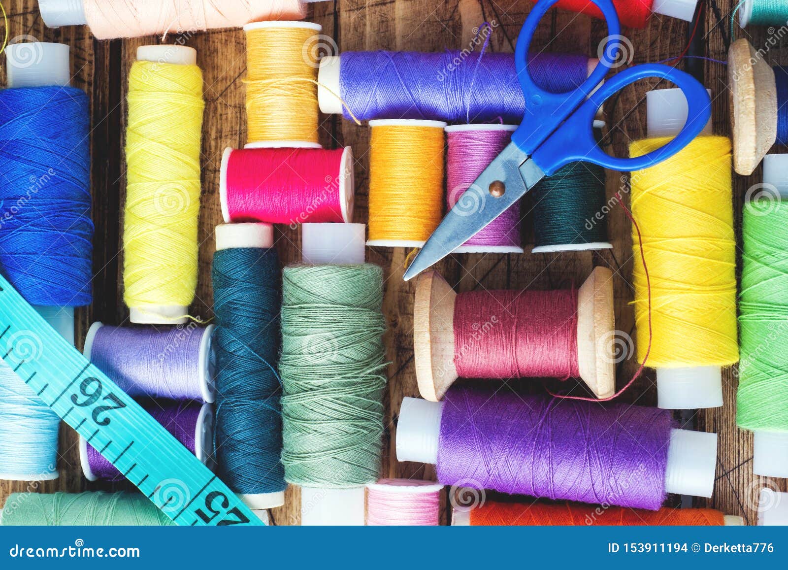 Colored Spools of Thread Laid Out in Rows on Wooden Background Stock ...