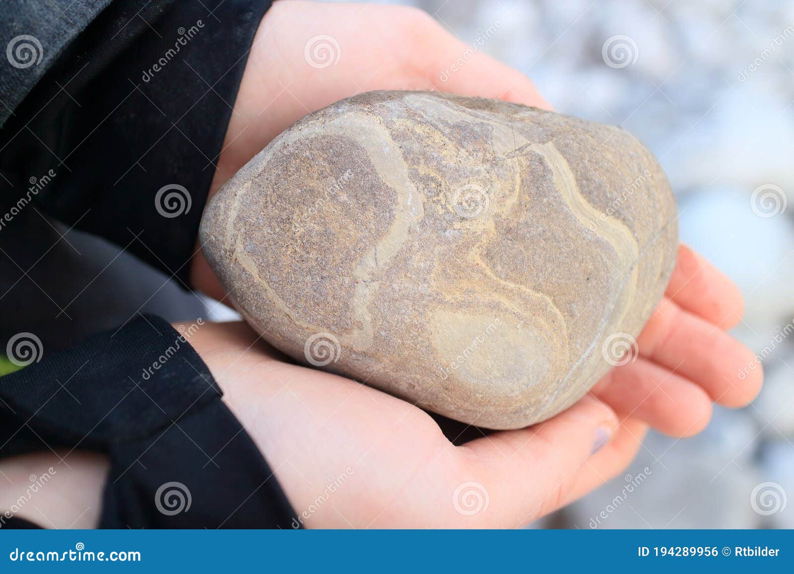 Colored stone in hand stock photo. Image of hold, pebble - 194289956