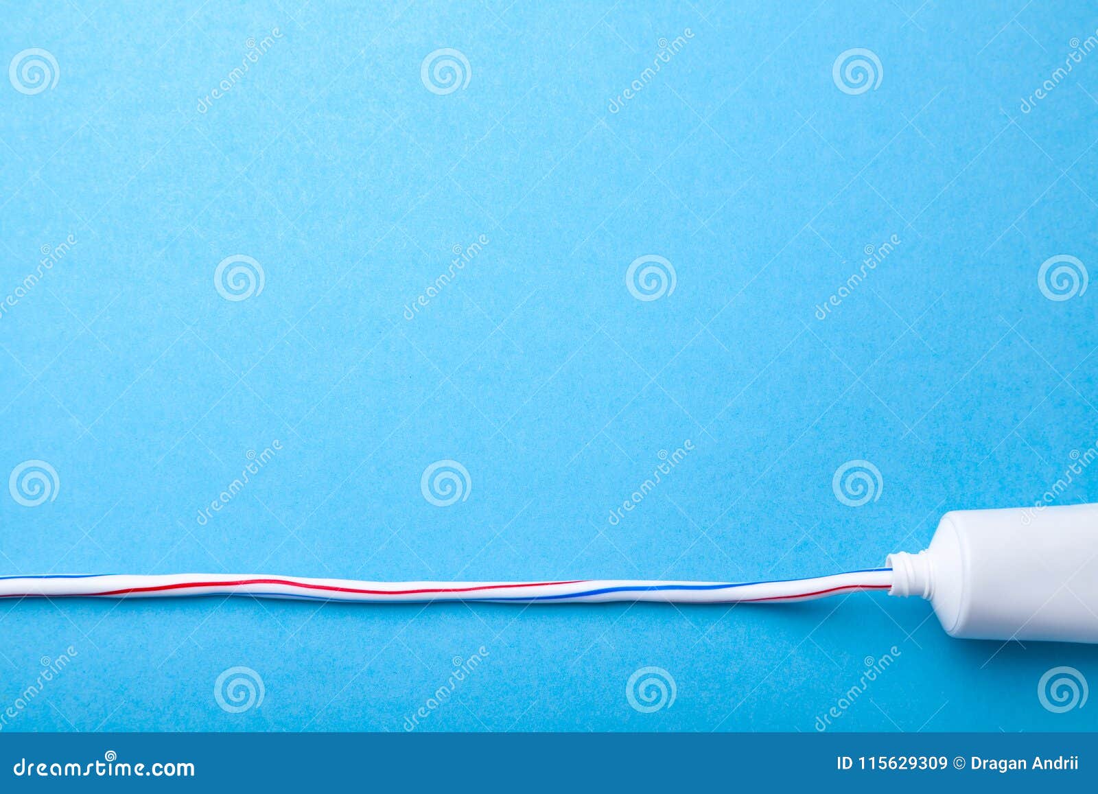 Colored Toothpaste Squeezed Out Line from Tube on Blue Stock Image ...