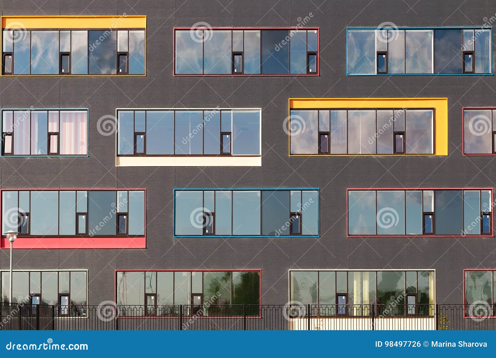Colored Windows Of The Building With The Sky Reflected In The Glass ...