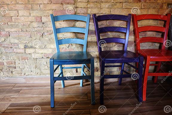 Colored wooden chairs stock image. Image of blue, wall - 124677143
