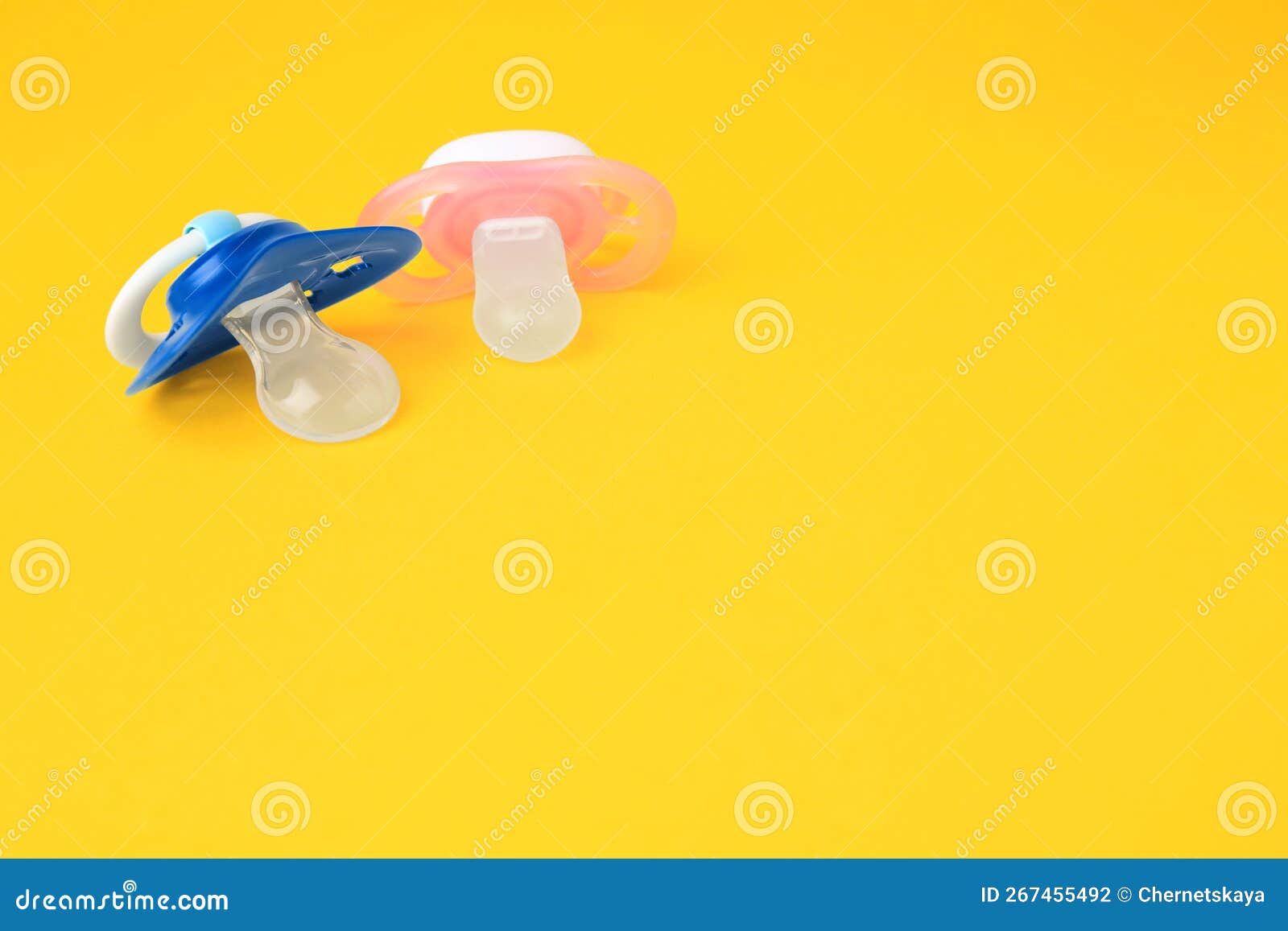 Colorful Baby Pacifiers on Orange Background. Space for Text Stock ...