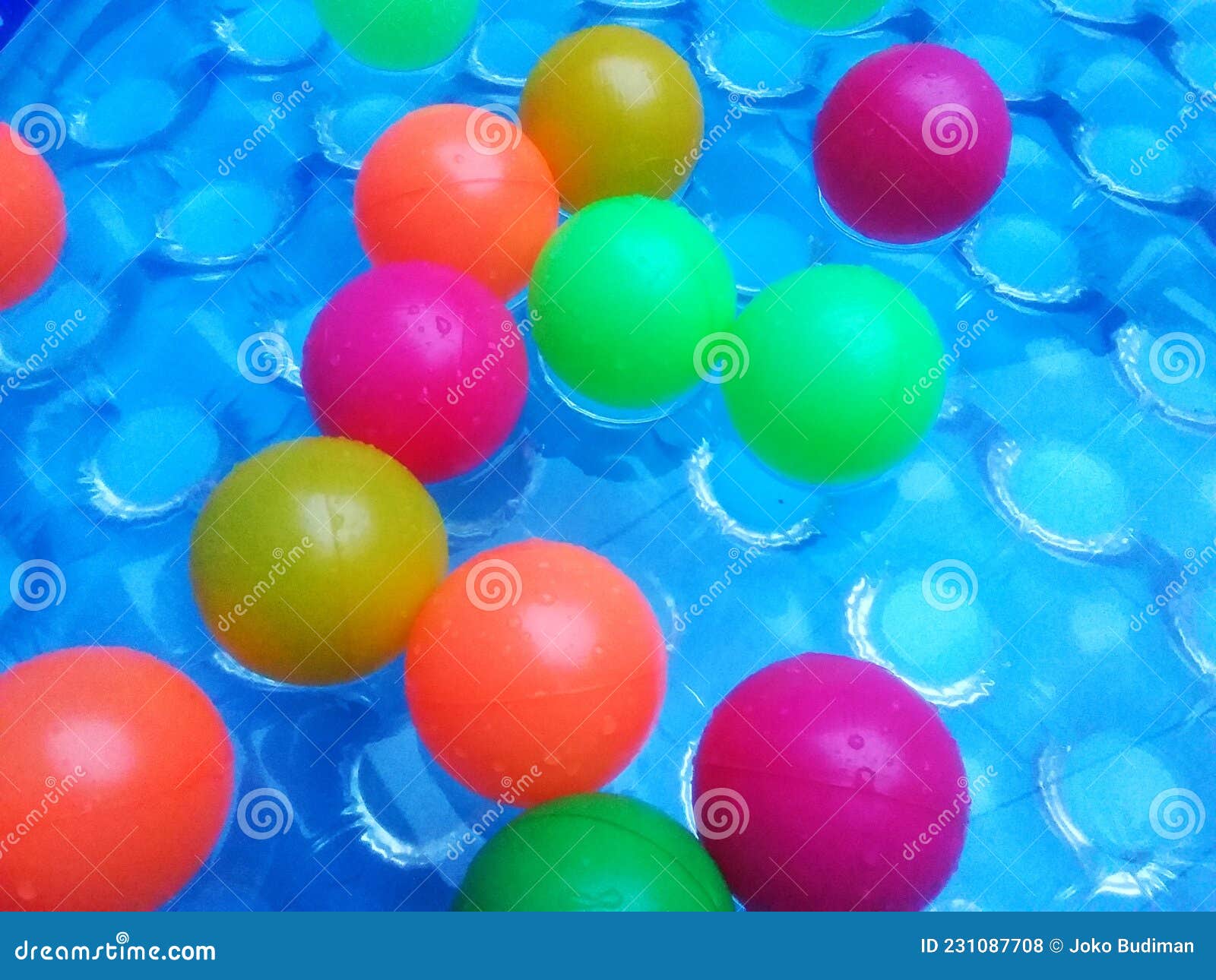 Colorful Balls Floating in the Pool Water Stock Photo - Image of ...