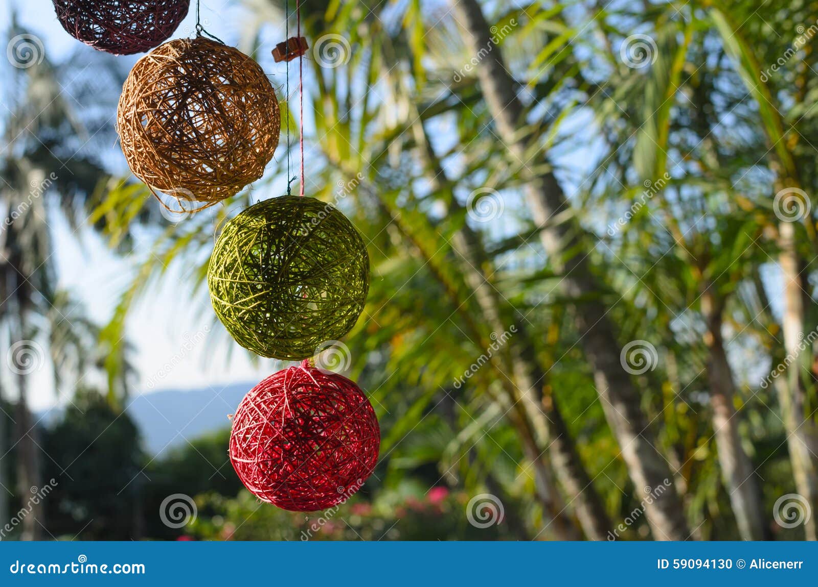 Colorful Balls Made of Natural Thread Hanging in Front of Palm Tree ...