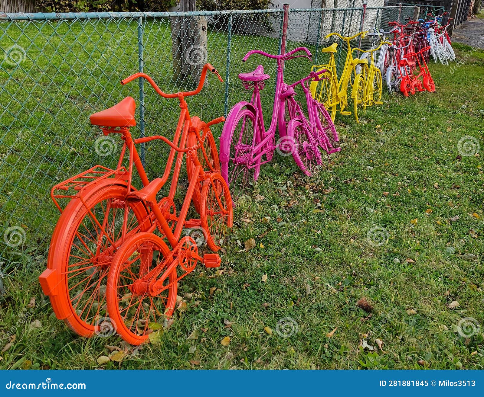 Colorful Bicycles on the Grass Stock Image - Image of fence, color ...