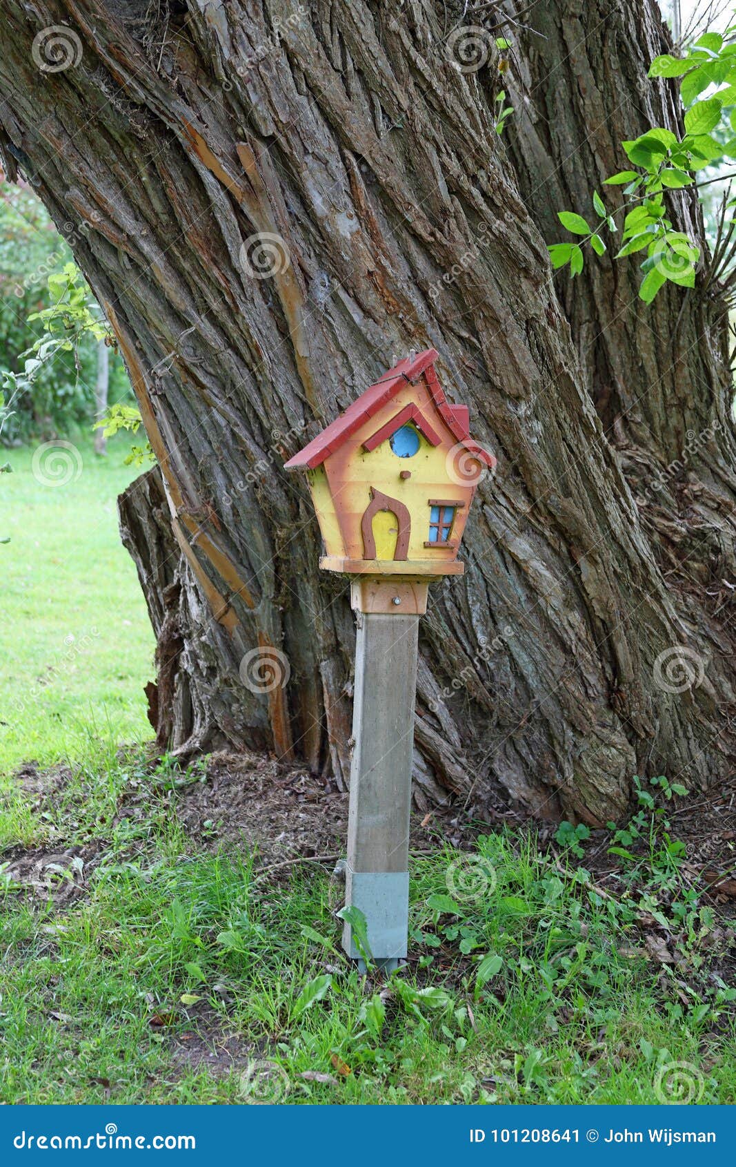 Colorful Birdhouse on a Post in Front of a Tree Stock Image - Image of ...