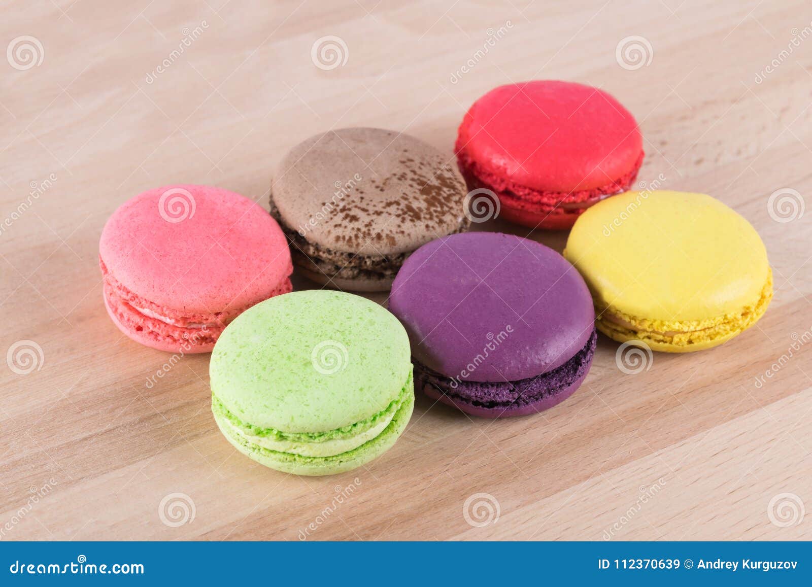 Colorful Biscuits Lie in Two Rows on a Light Wooden Table Stock Image ...