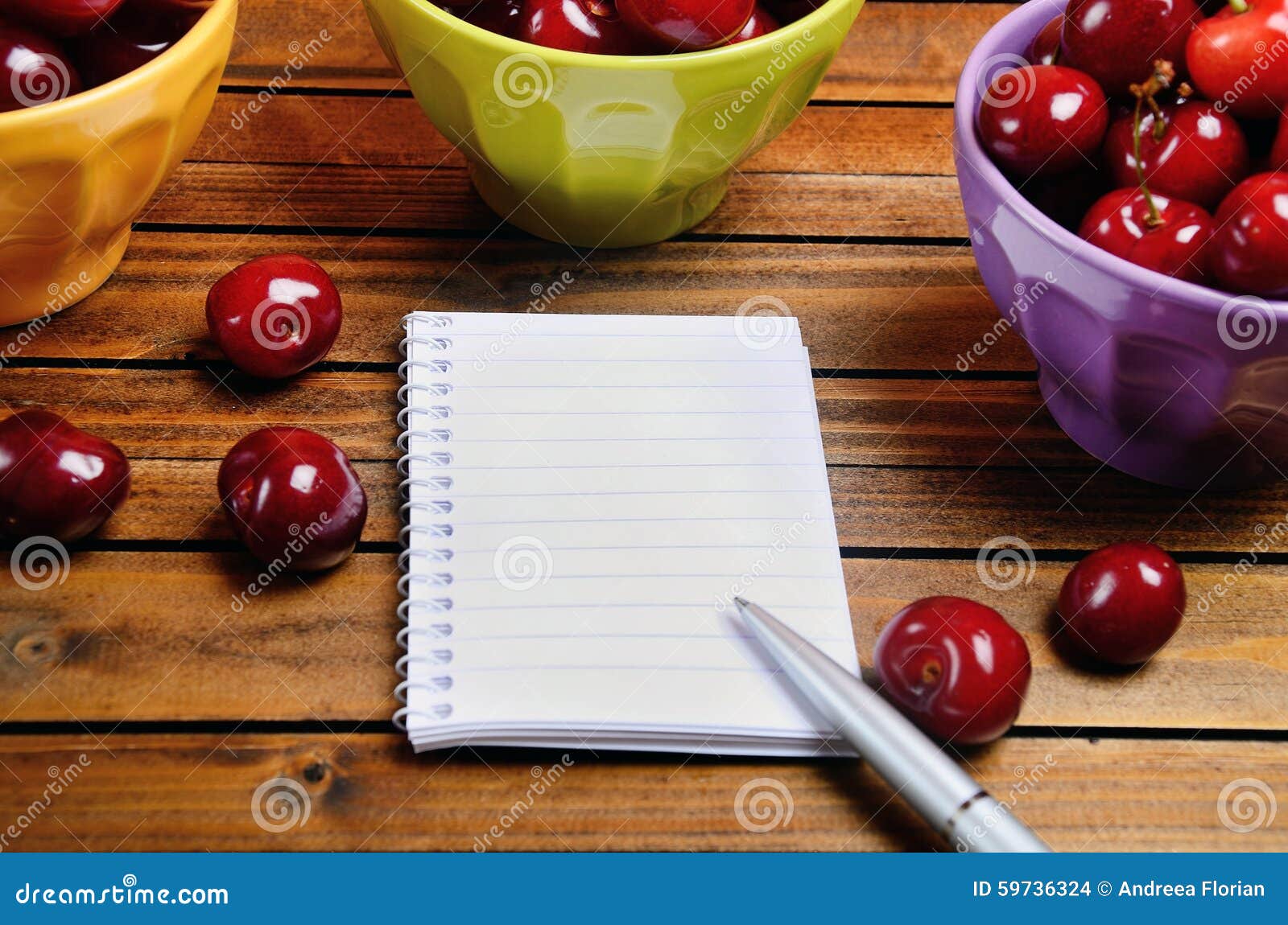 Colorful Bowl with Cherries Stock Photo - Image of notebook, bowl: 59736324