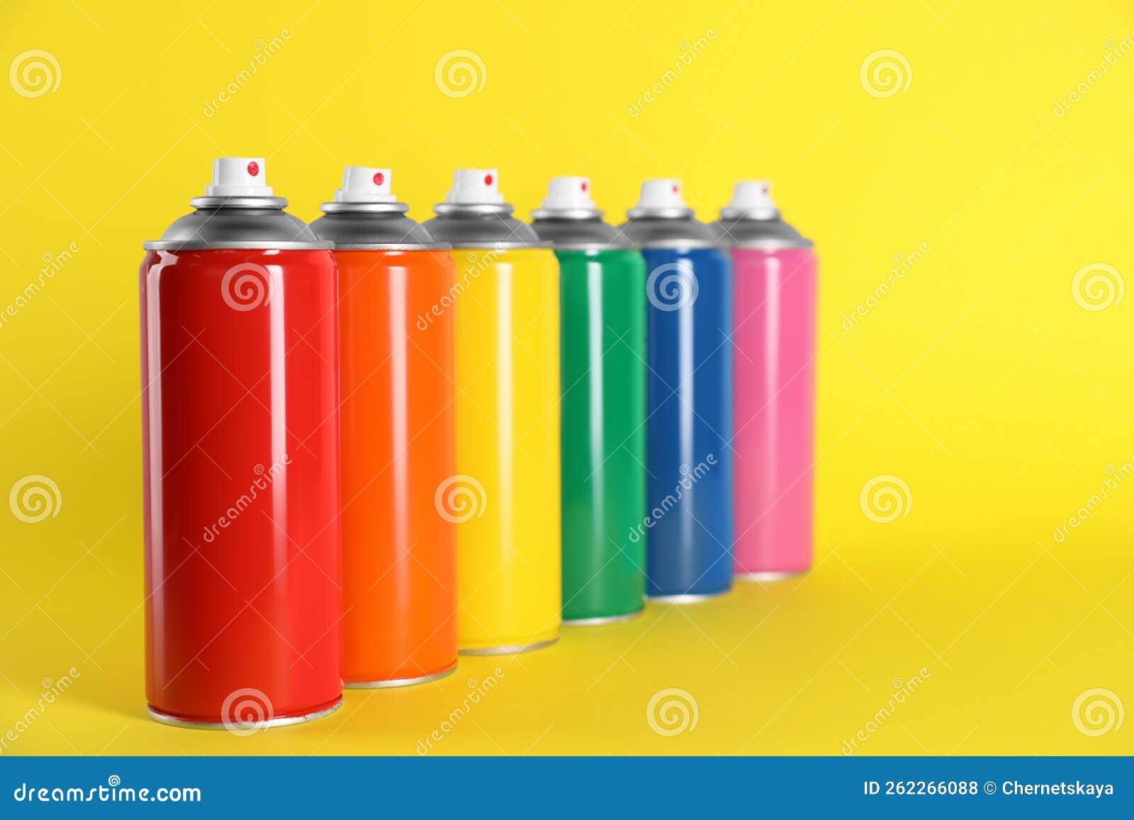Colorful Cans of Spray Paints on Yellow Background Stock Photo - Image ...