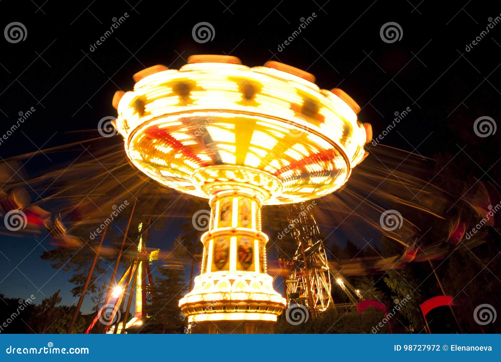 Colorful Chain Swing Carousel in Motion at Amusement Park at Night ...