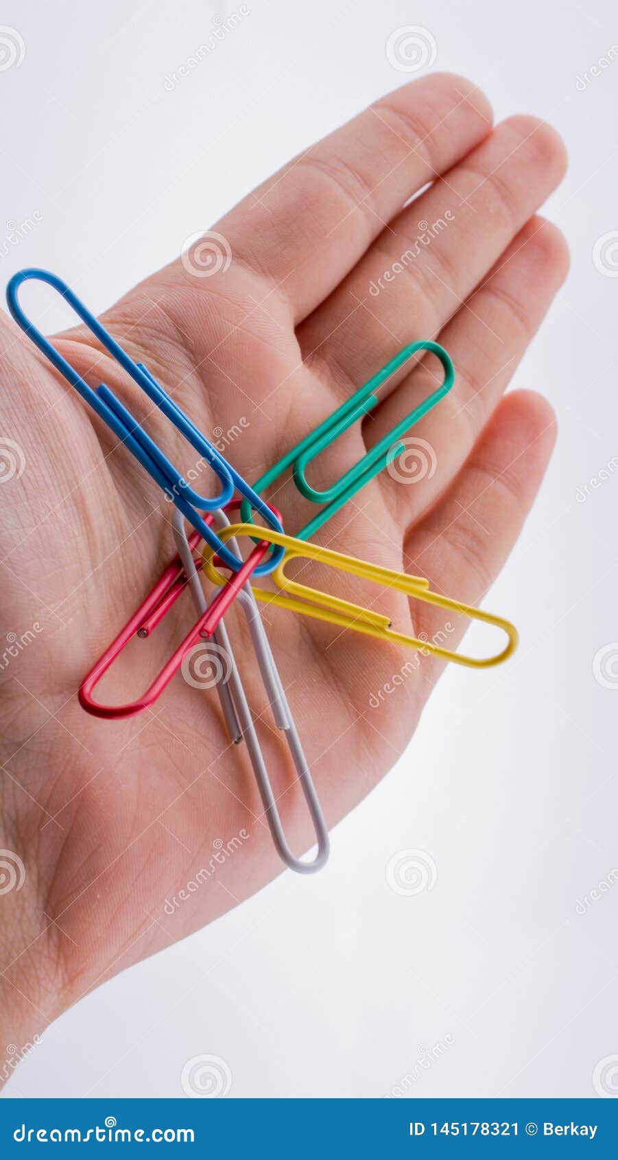 Colorful Clips Placed in a Hand on White Background Stock Image - Image ...