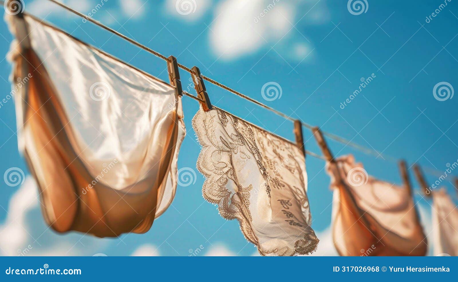 Colorful Clothes Hanging on a Clothesline Against a Backdrop of Fluffy ...
