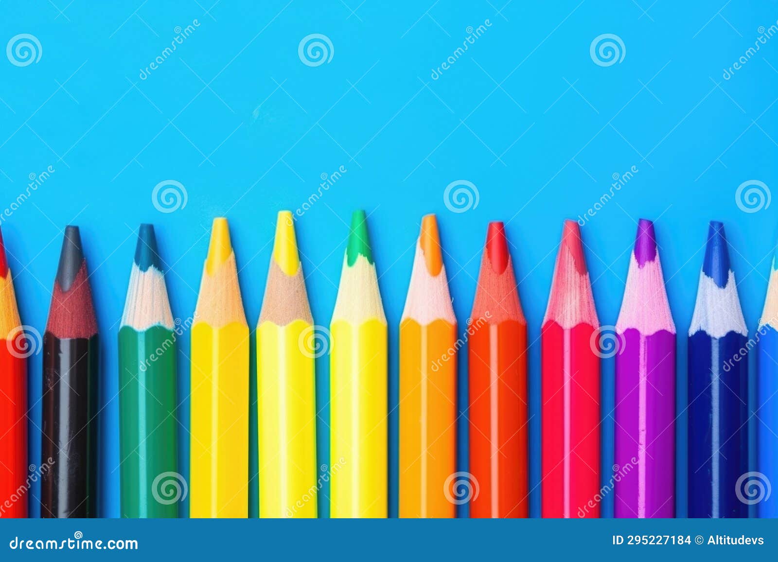 Colorful Crayons in a Row on Bright Blue Paper Stock Photo - Image of ...
