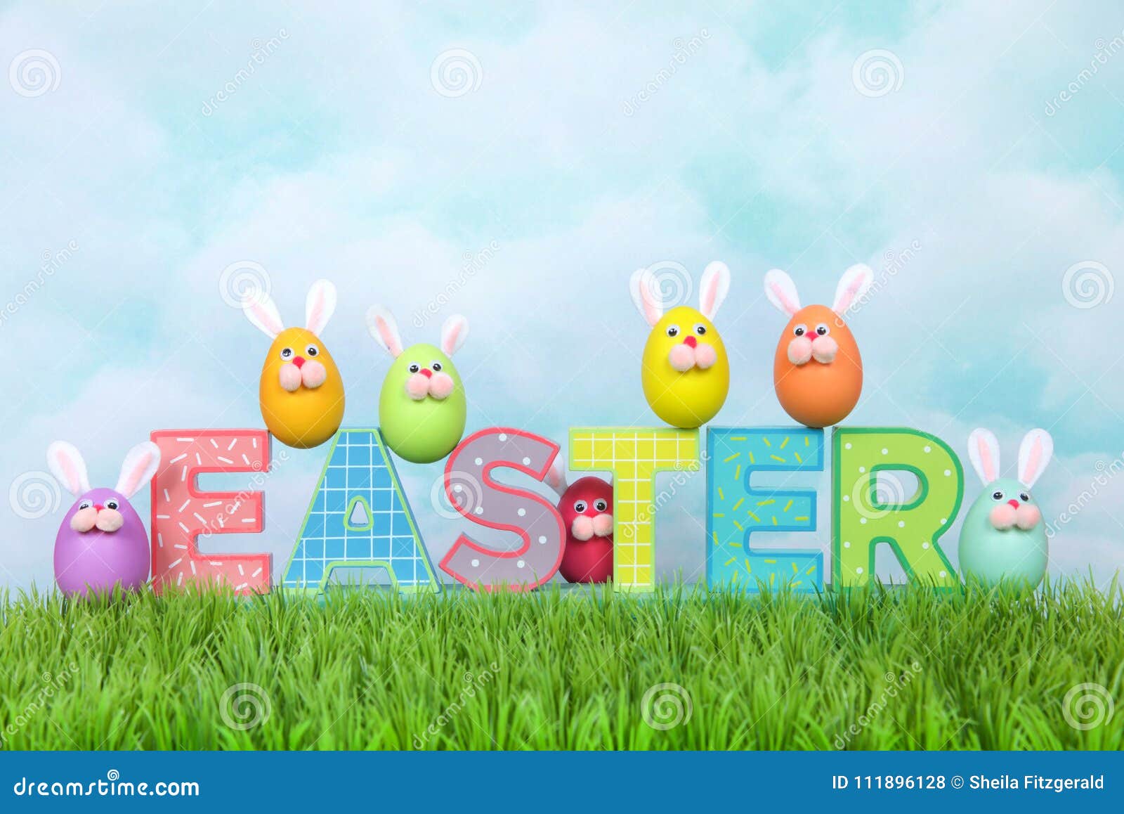 Funny Faces Easter Bunny Eggs on Wooden EASTER Sign in Grass Stock ...