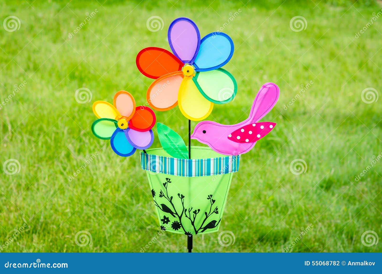Colorful Double Pinwheel with Bird on Green Grass Stock Photo - Image ...