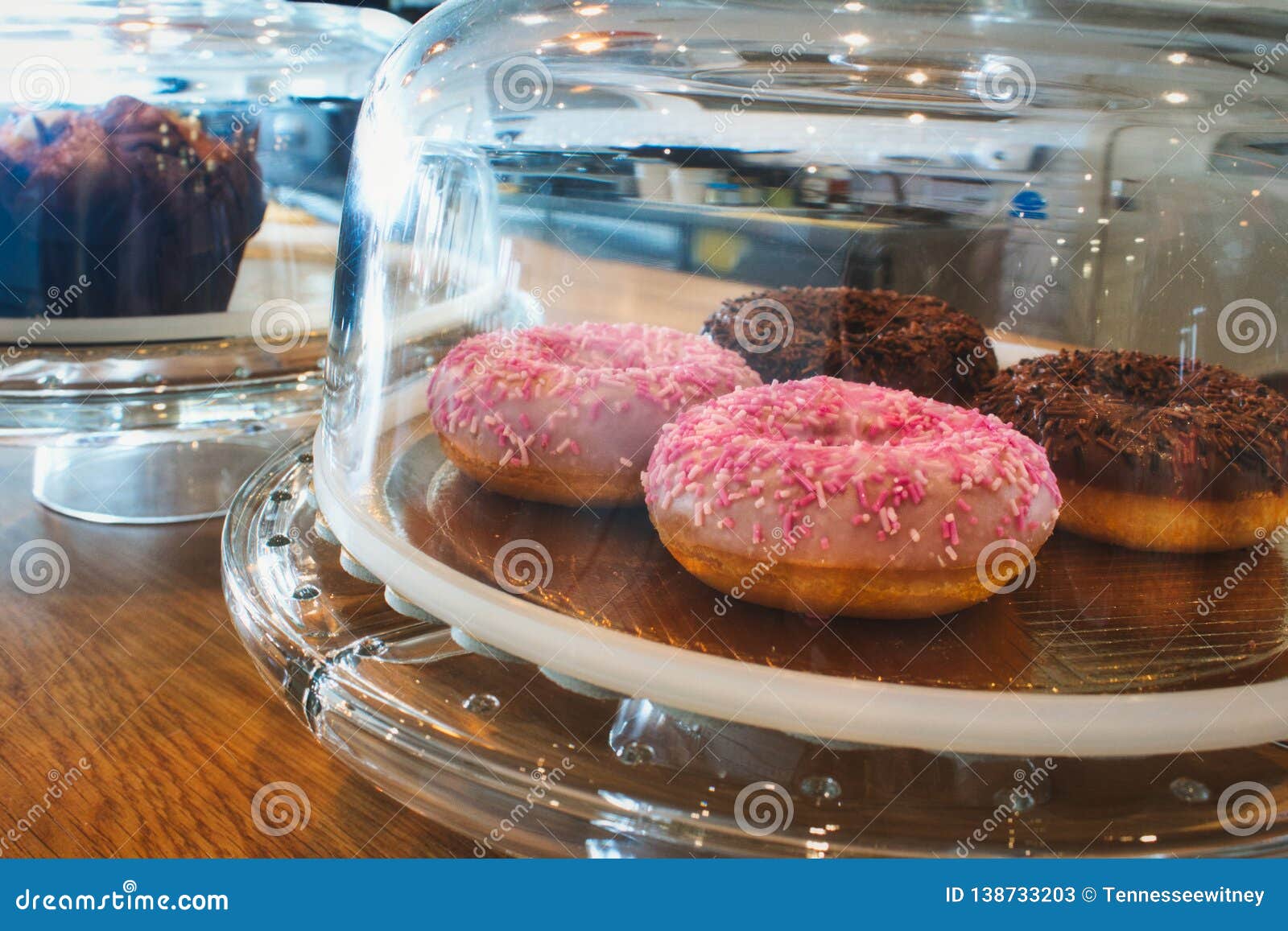 Colorful Doughnuts in a Glass Display Container on a Shop Counter Stock ...