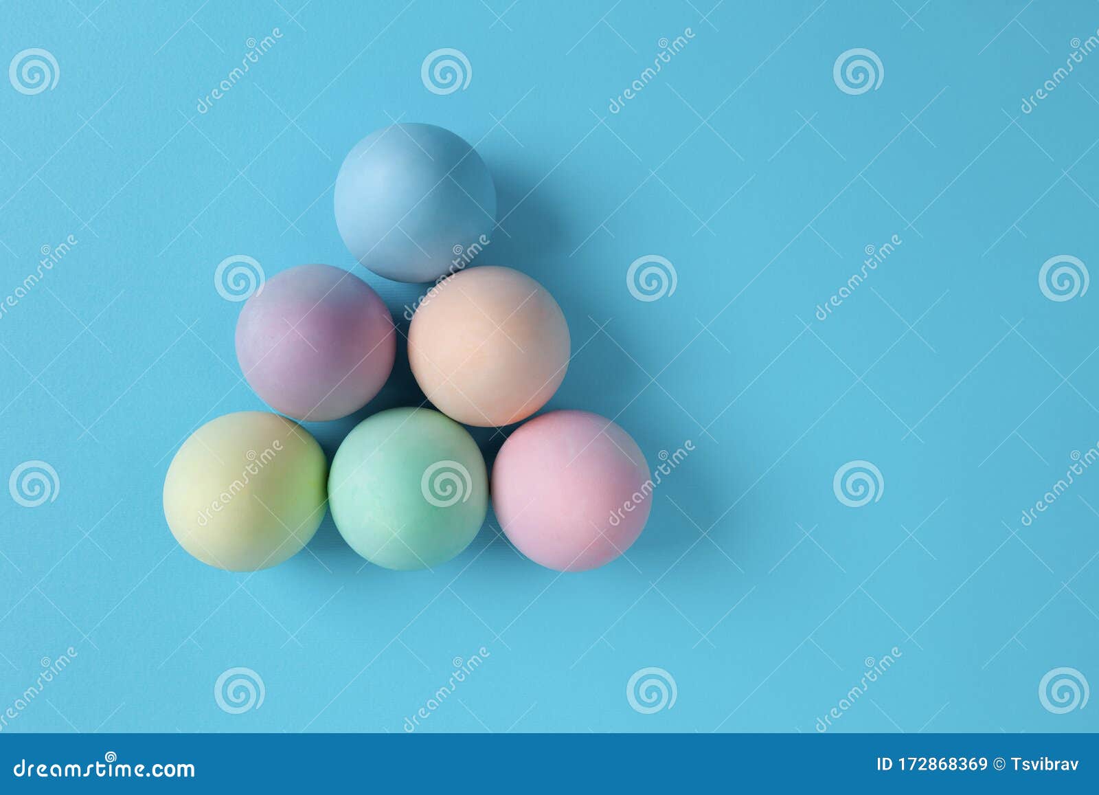 Colorful Easter Eggs in Triangle Shape on Blue Background Stock ...