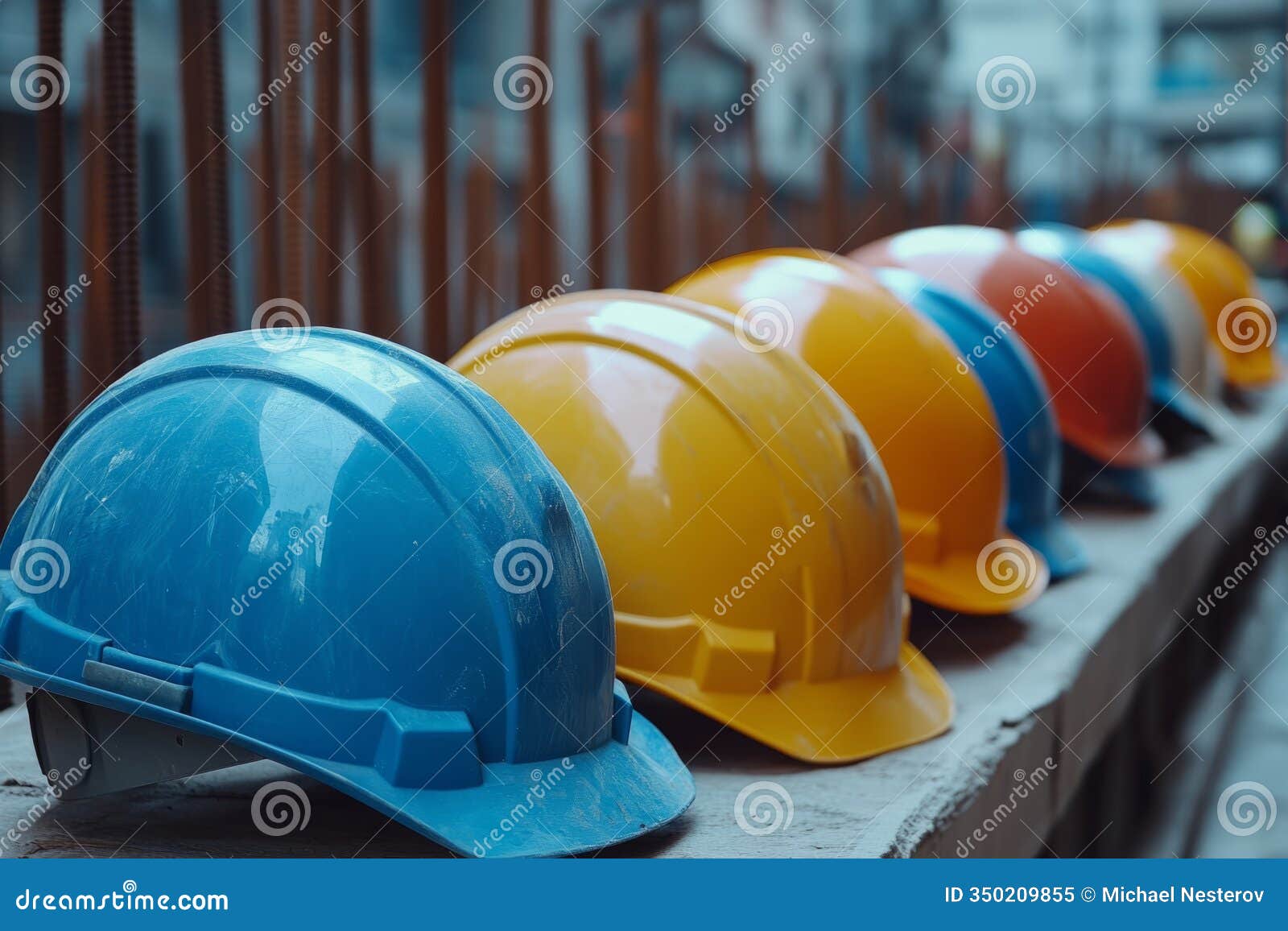 Colorful Hard Hats Resting on Concrete Beam at Construction Site ...