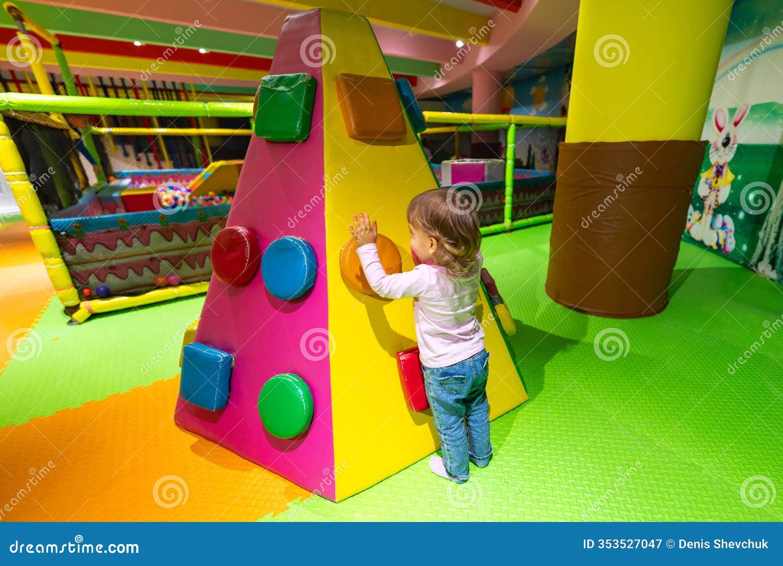 A Colorful Indoor Playground with a Soft Climbing Wall for Kids Fun and ...