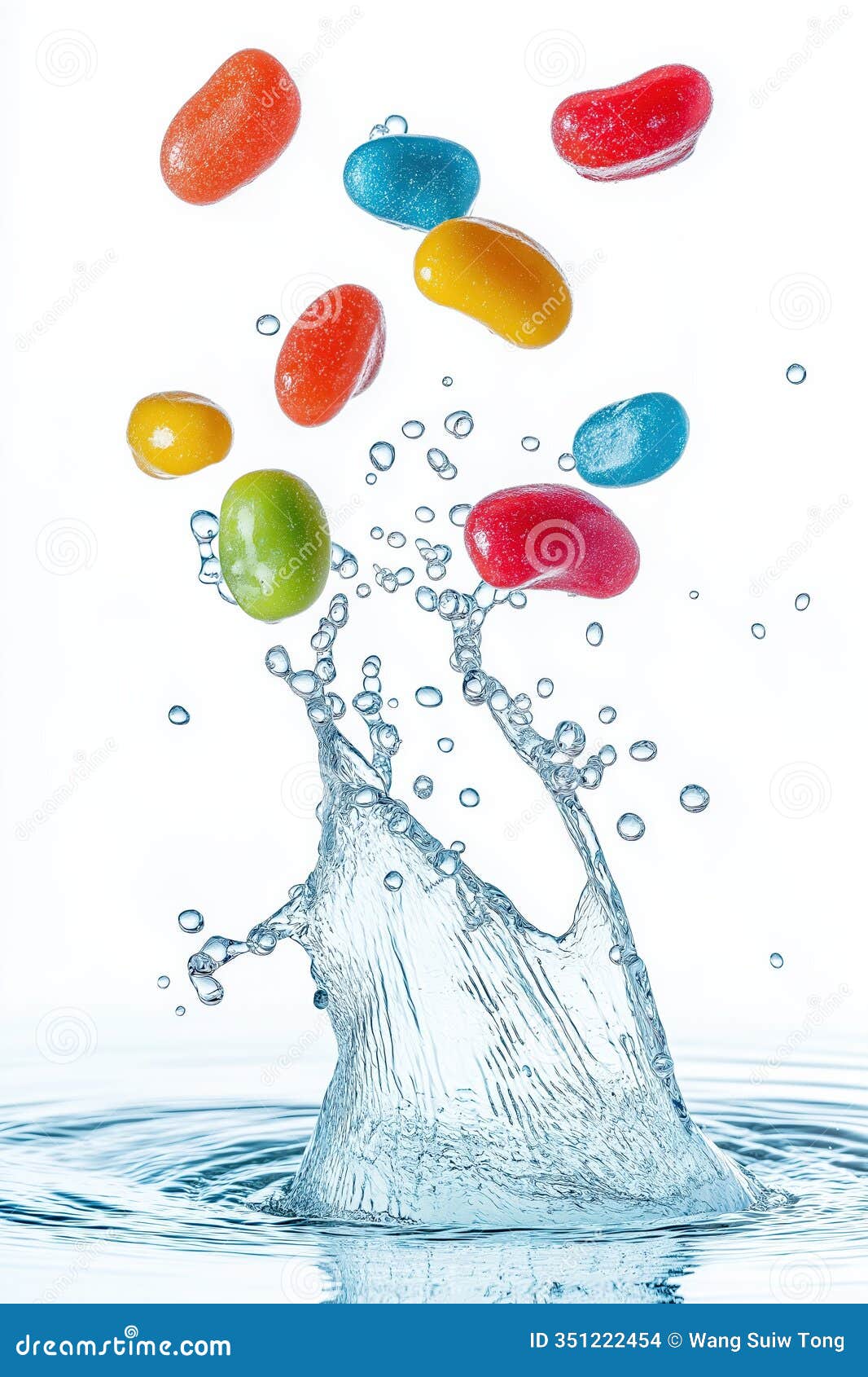 Colorful Jelly Beans Falling into Water Creating Splash Stock ...