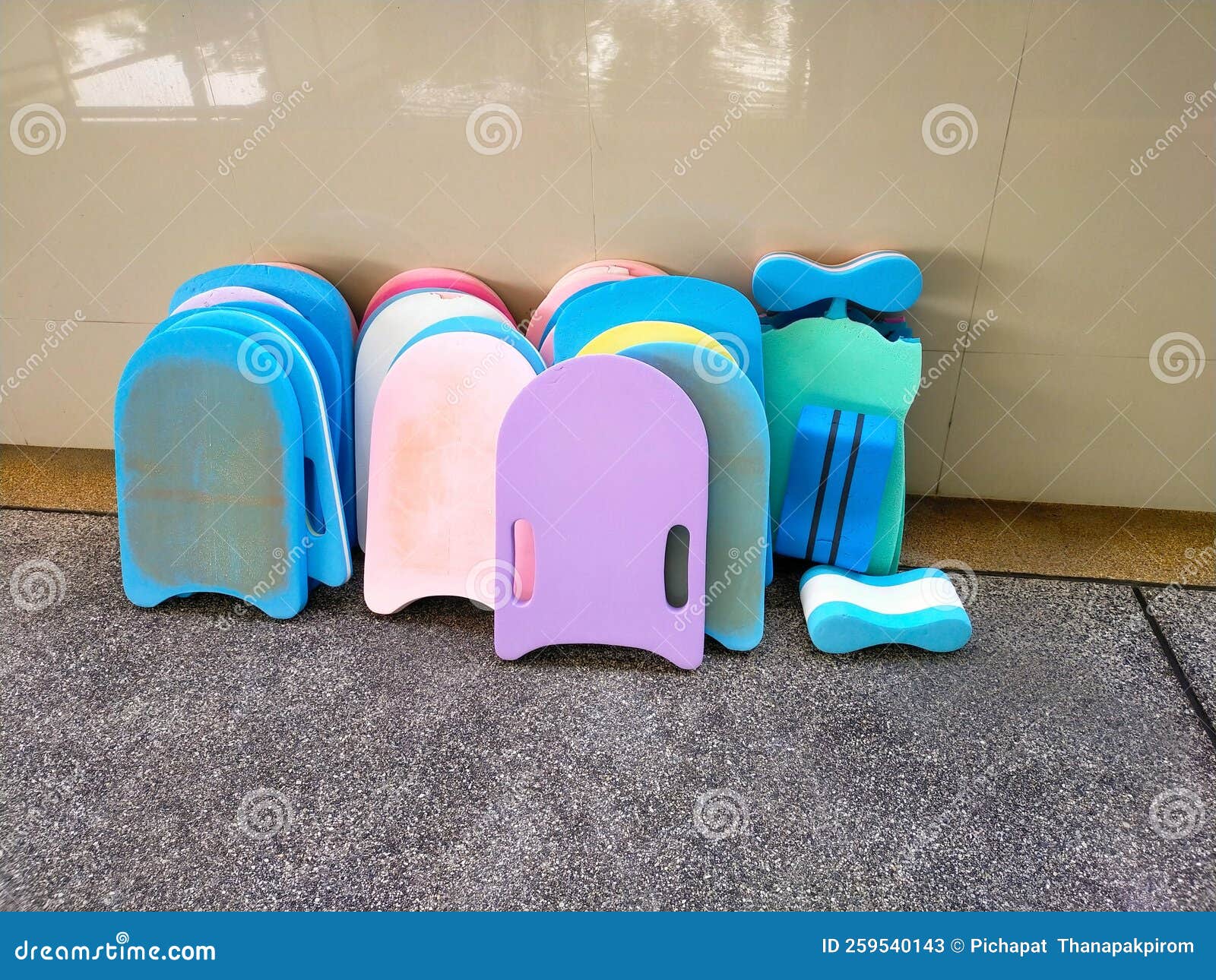 Colorful Swimming Kickboards Placed Against the Wall of a Swimming Pool ...