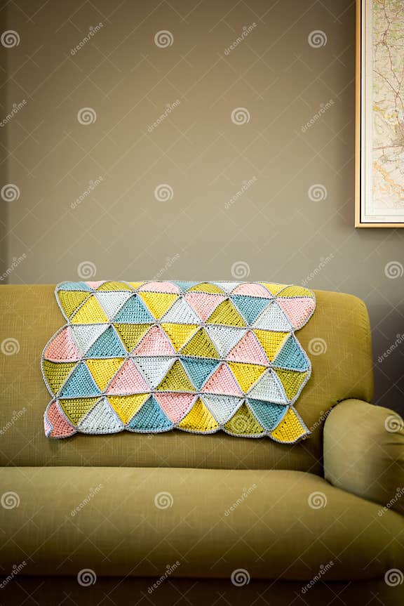 Colorful Knitted Triangle Pattern Decorative Mat on Couch Stock Photo ...